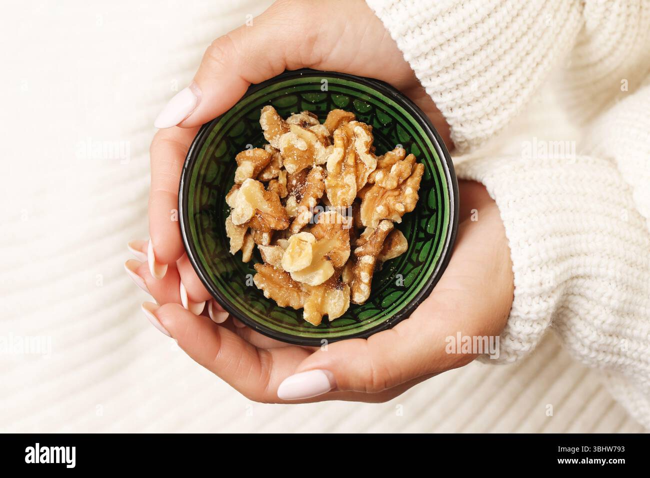 Hands holding walnut bowl. Healthy food rich in nutrients. Natural nut ...