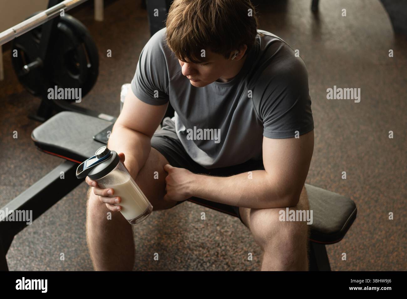 Close up shot of man at gym holding protein shaker. Bodybuilder during ...