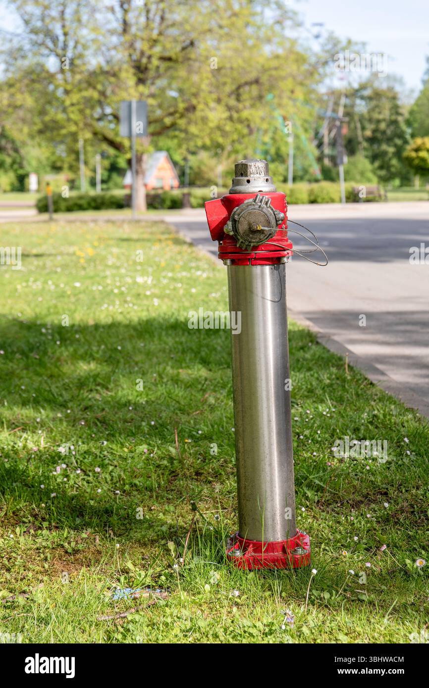 Red and Silver Fire Hydrant Installed on Grass Lawn in Urban Public ...
