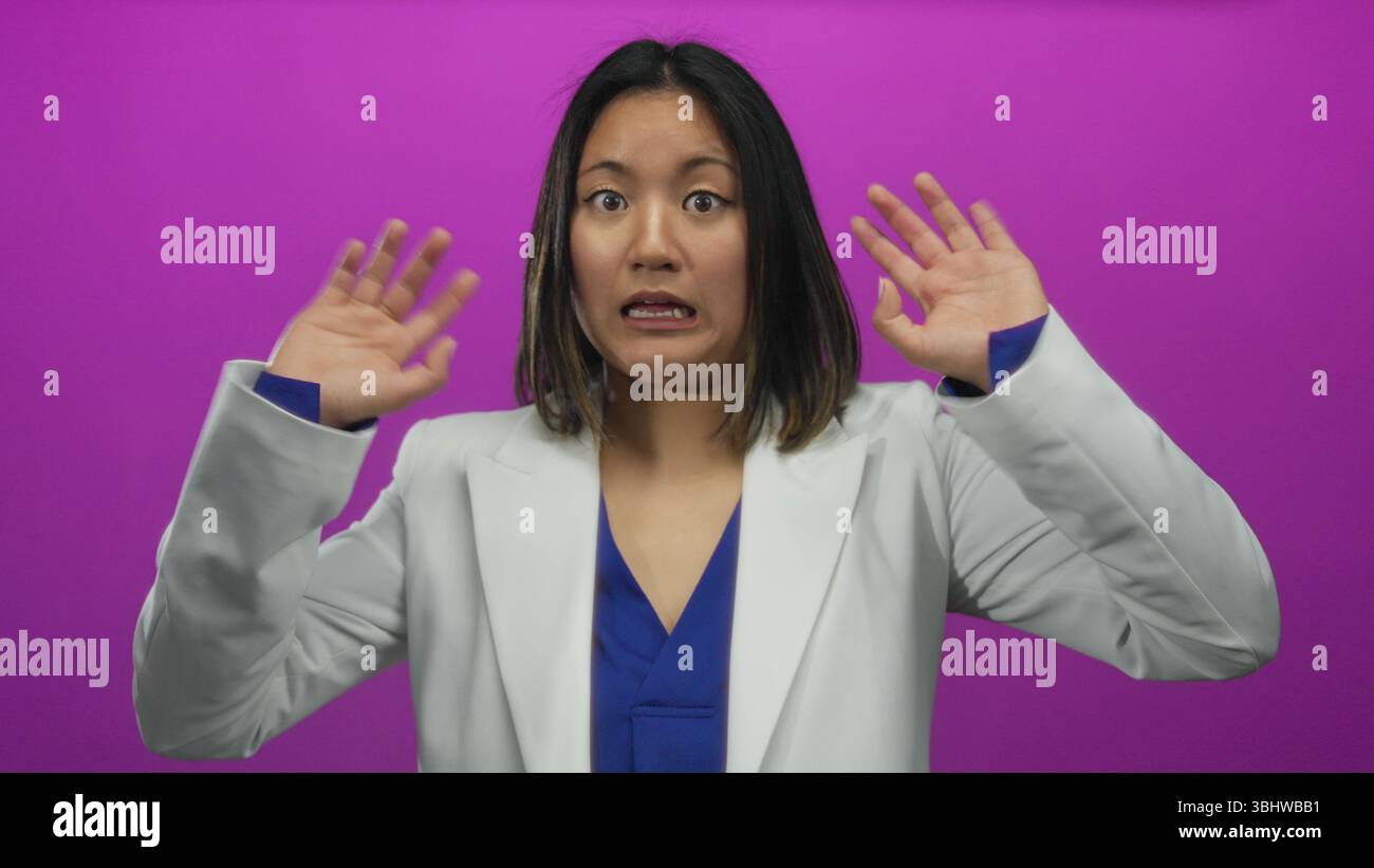 Woman expressing surprise and curiosity in a white blazer over a vivid ...