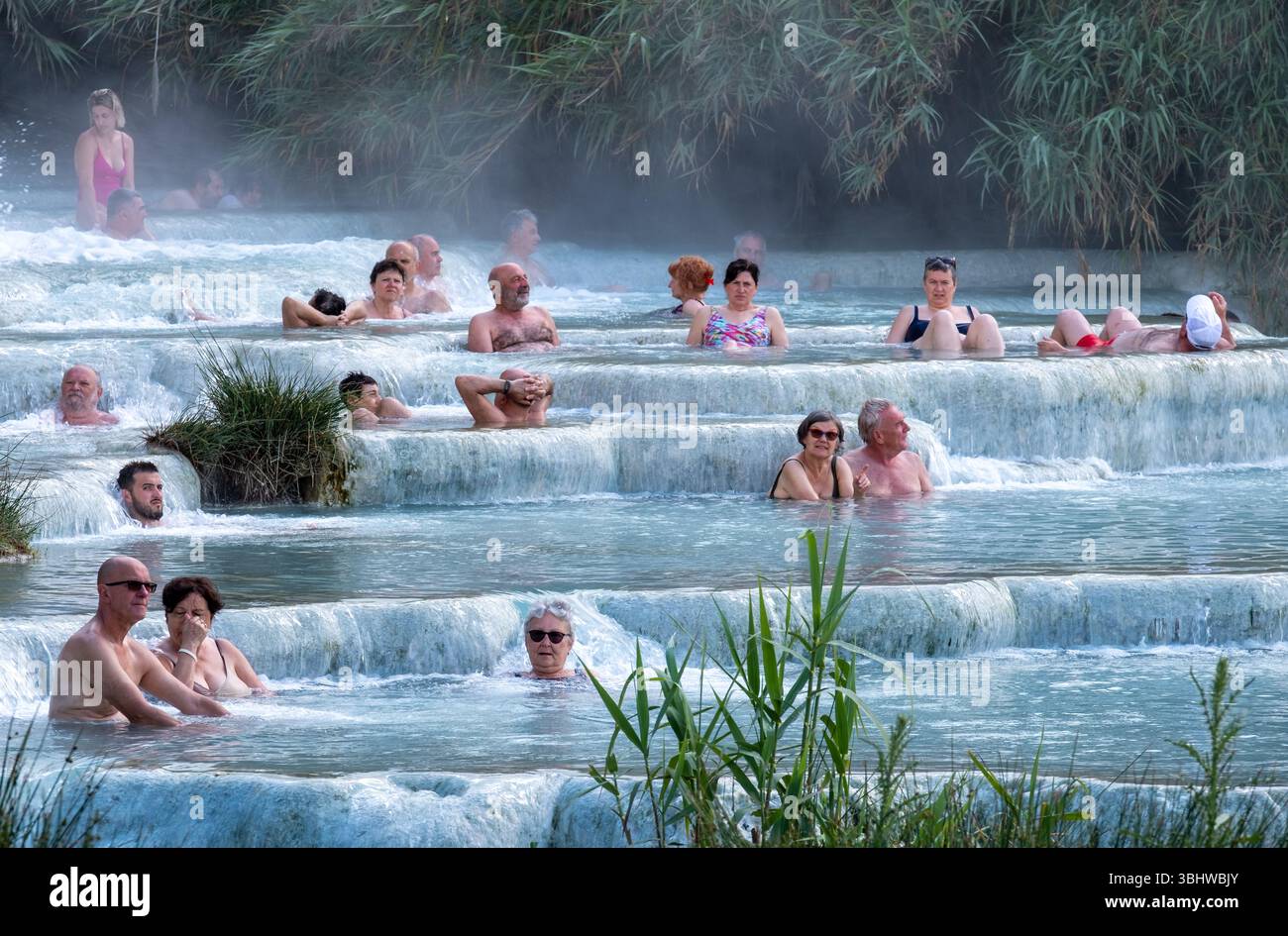 People bathe in the natural bubbling thermal waters hot springs in ...
