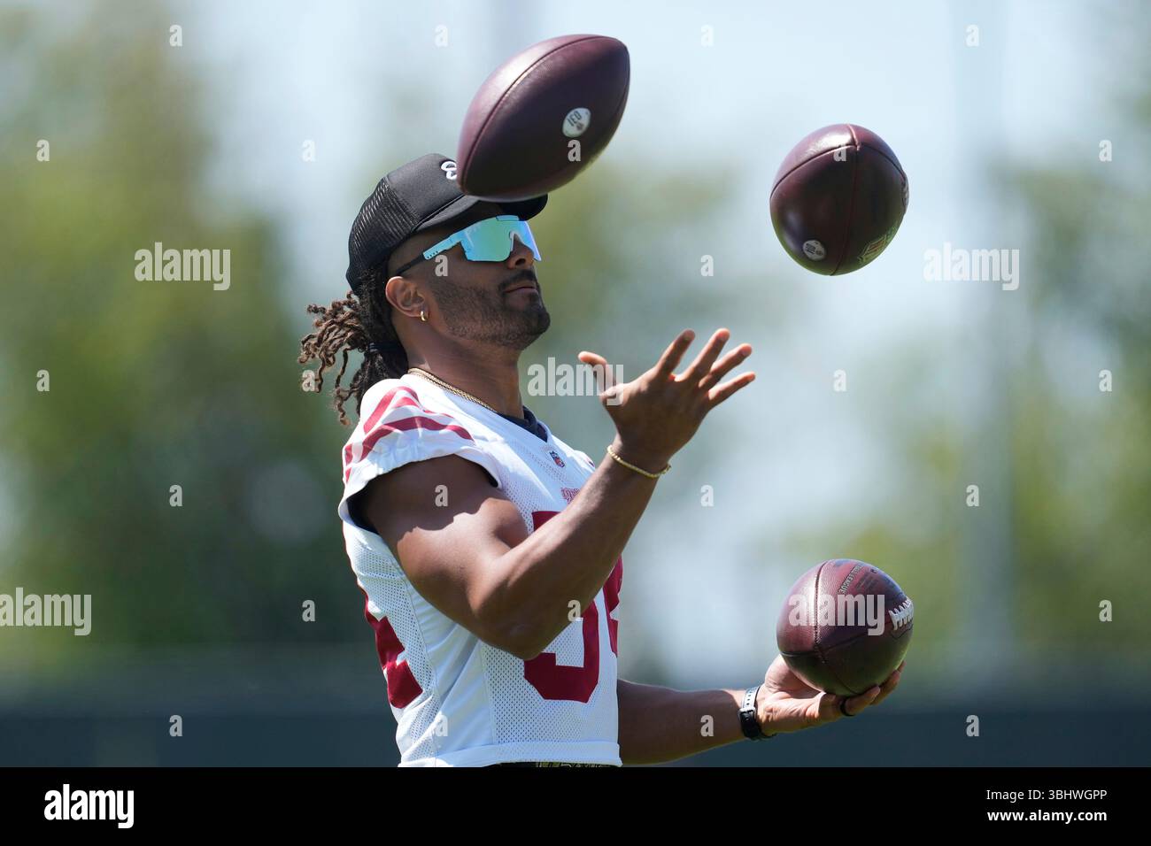 San Francisco 49ers linebacker Fred Warner juggles footballs during ...
