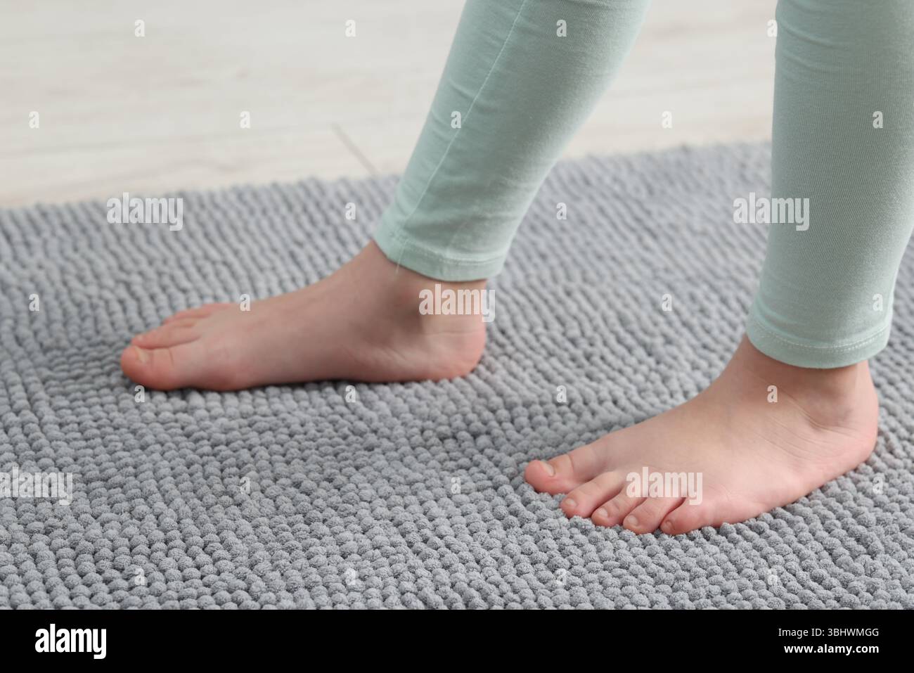 Girl on soft carpet at home, closeup Stock Photo - Alamy