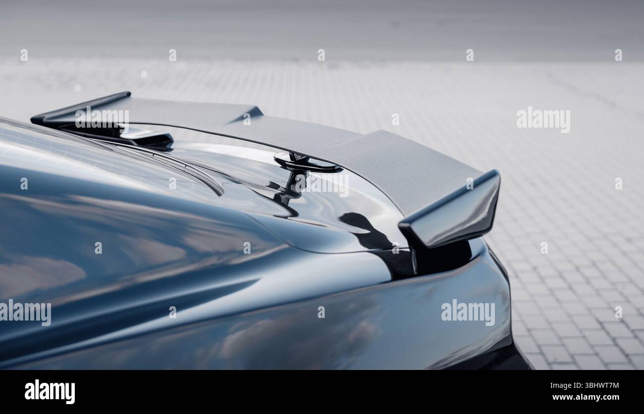 Rear spoiler on black car. Aerodynamic element on the top of car trunk ...