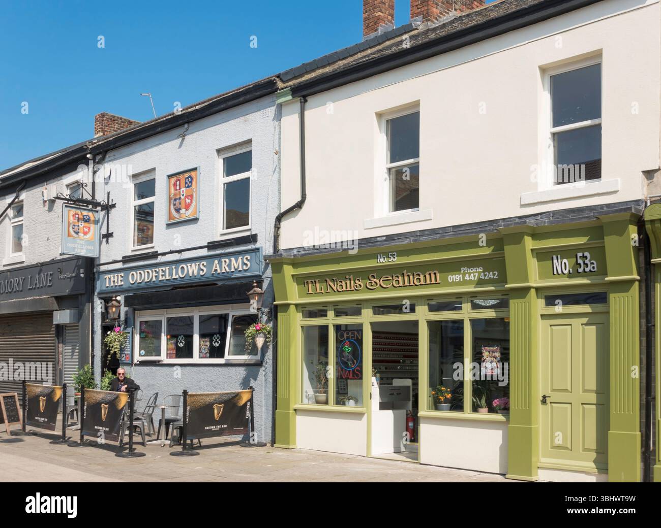Man sitting outside the Oddfellows pub in Seaham, Co. Durham, England ...
