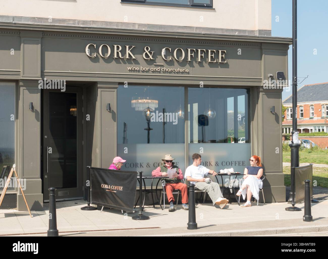 People sitting outside the Cork & Coffee Wine Bar & Charcuterie in ...