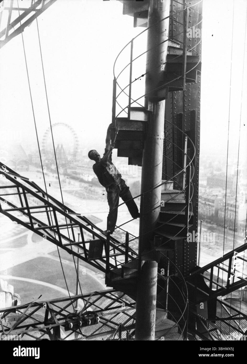A construction worker high up on the Eiffel Tower in Paris Stock Photo ...