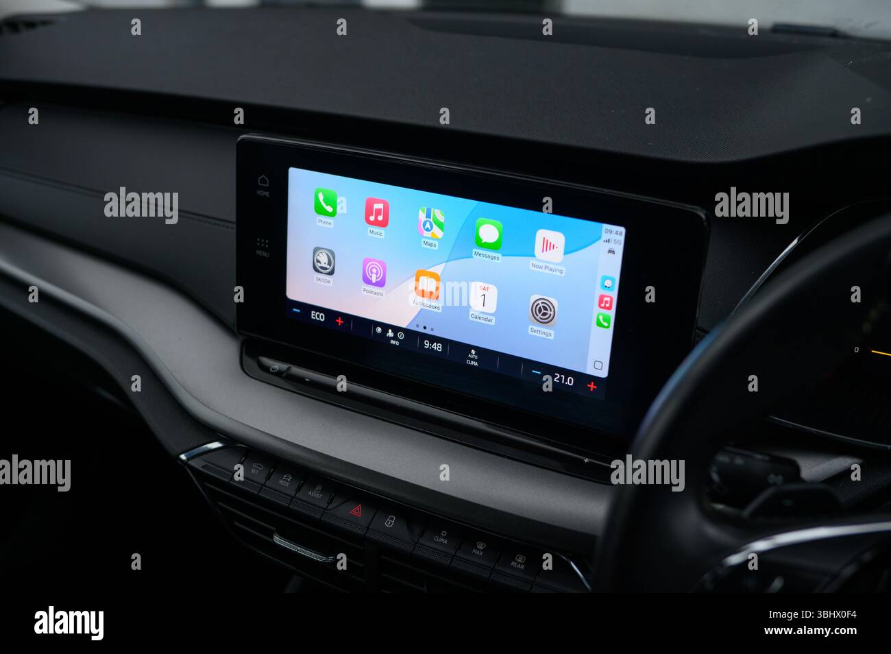 This image captures a modern car dashboard with Apple CarPlay active on ...