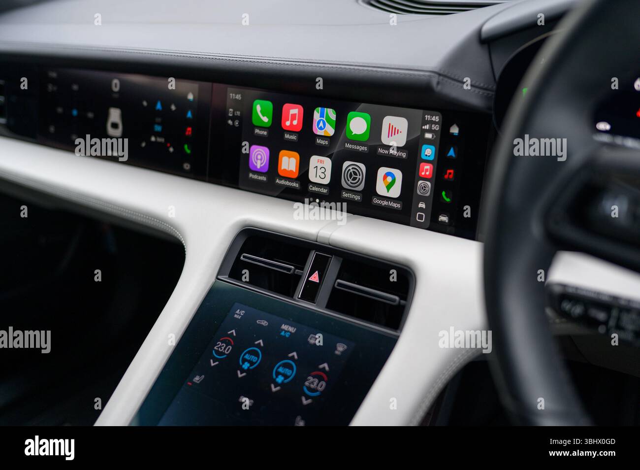 This image captures a modern car dashboard with Apple CarPlay active on ...