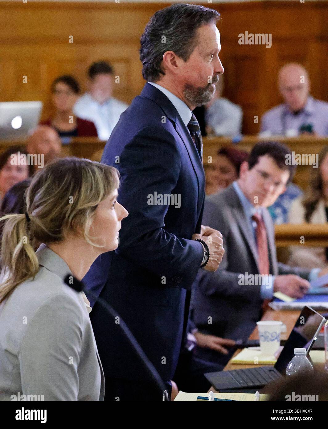 Defense attorney Alan Jackson stands to say the "Defense Rests" during ...
