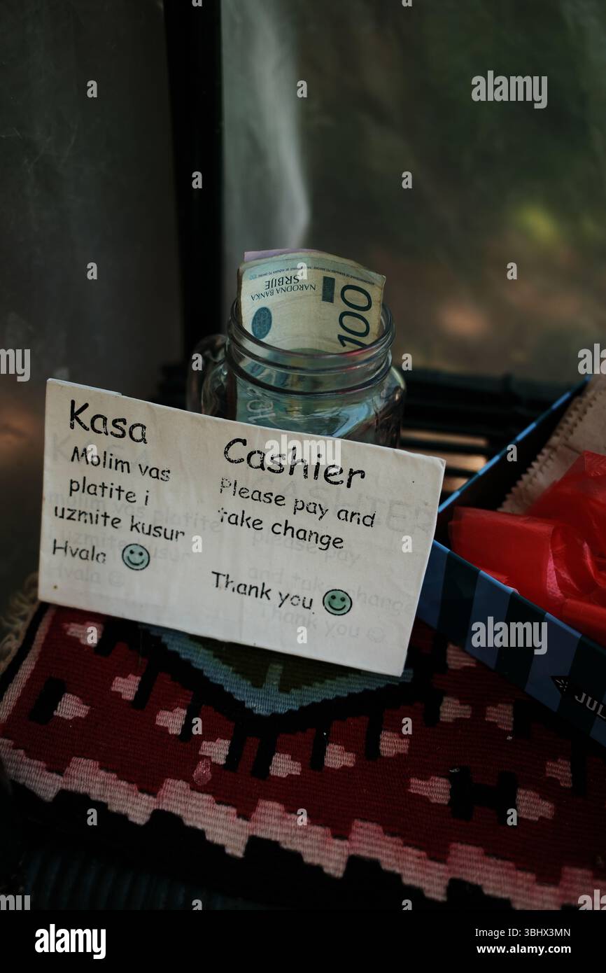 Bajina Basta, Serbia - 15 May 2025. Self-service cashier jar with Serbian dinars and a friendly ...