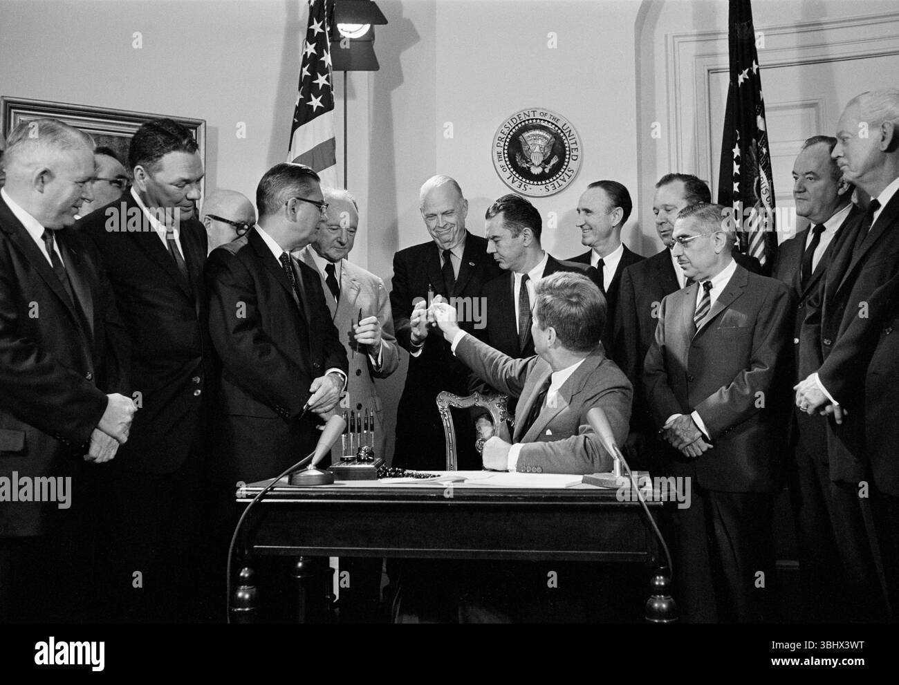 President John F. Kennedy hands a souvenir. pen to Sen. Robert S. Kerr ...