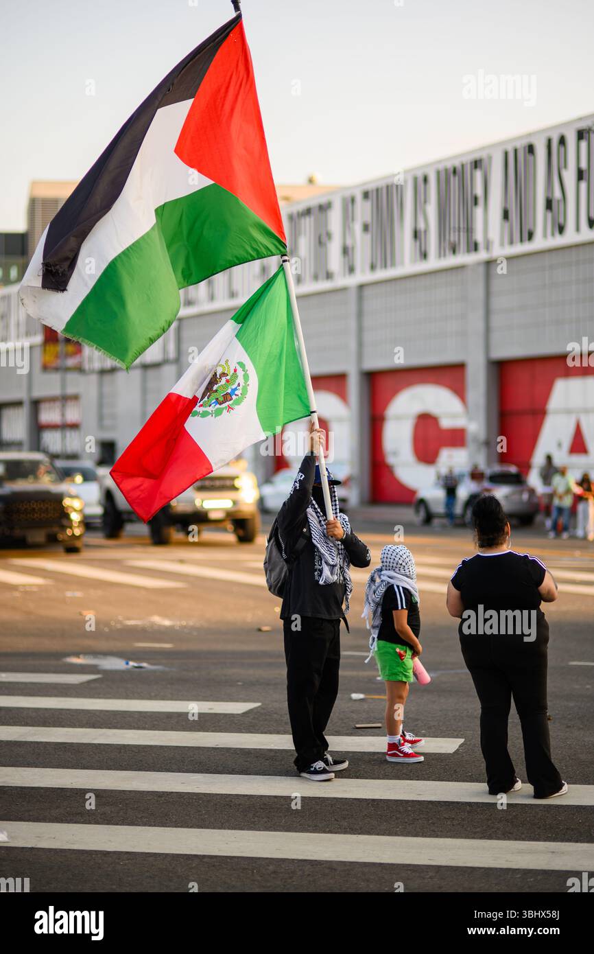 Protestors wearing a keffiyeh in downtown Los Angeles, waving ...