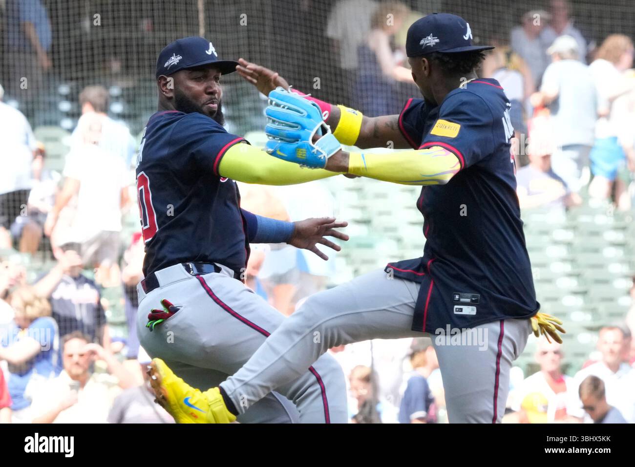 Atlanta Braves' hitter Marcell Ozuna, left, high-fives Ronald Acuña Jr ...