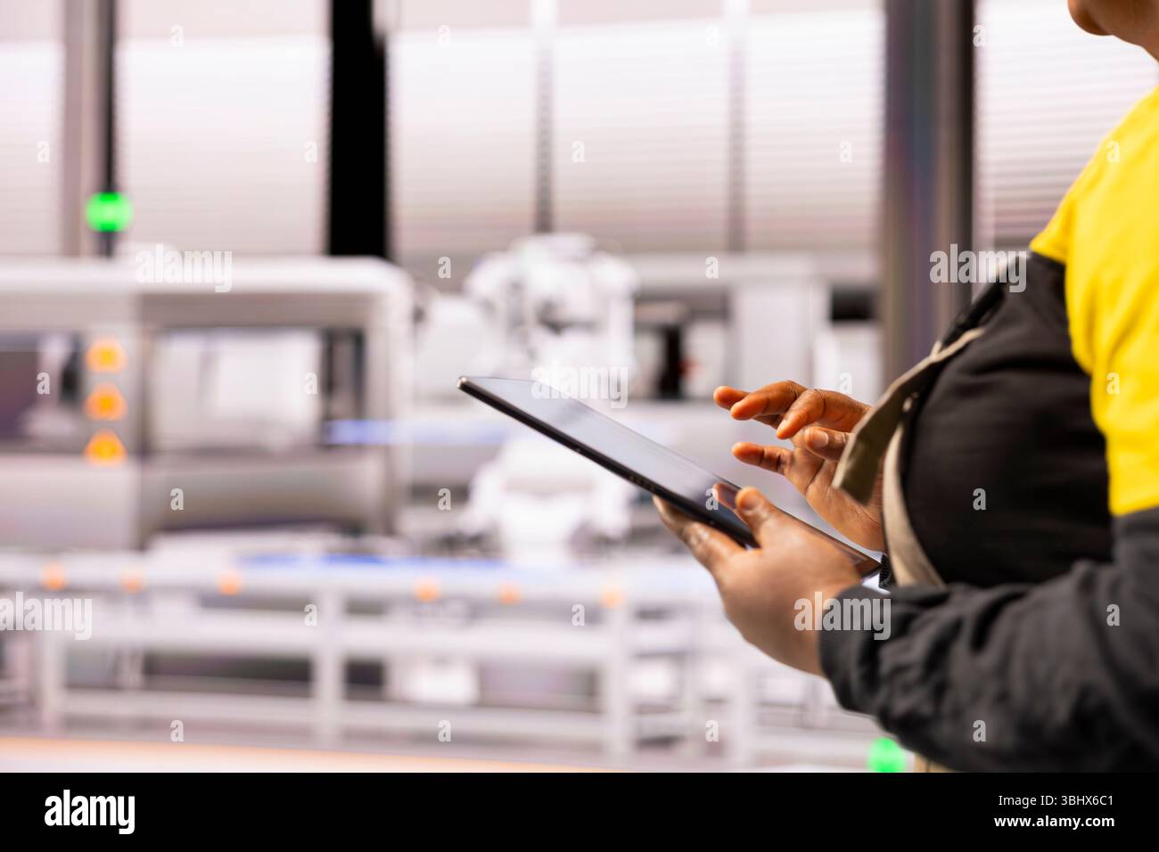 High tech industrial plant specialist programs and refines robot arm ...