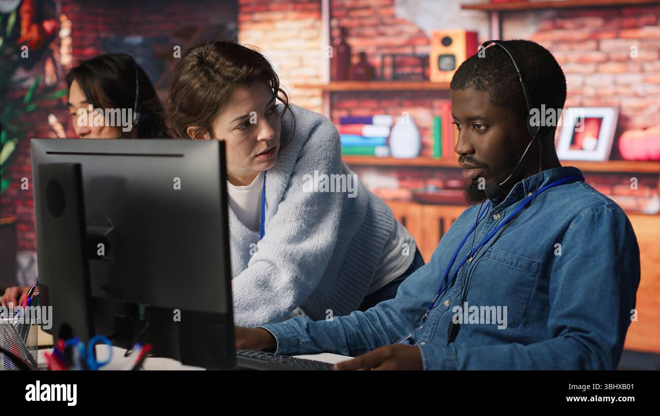 Call center manager teaching intern how to track clients shipment parcels. Customer center team ...