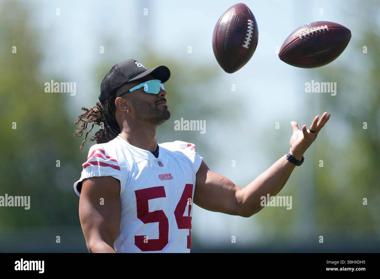San Francisco 49ers linebacker Fred Warner juggles footballs during ...