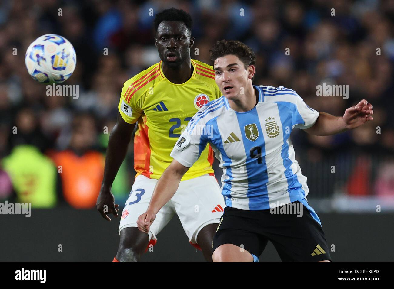 Argentina's national team forward Julian Alvarez (L) vies for the ball ...