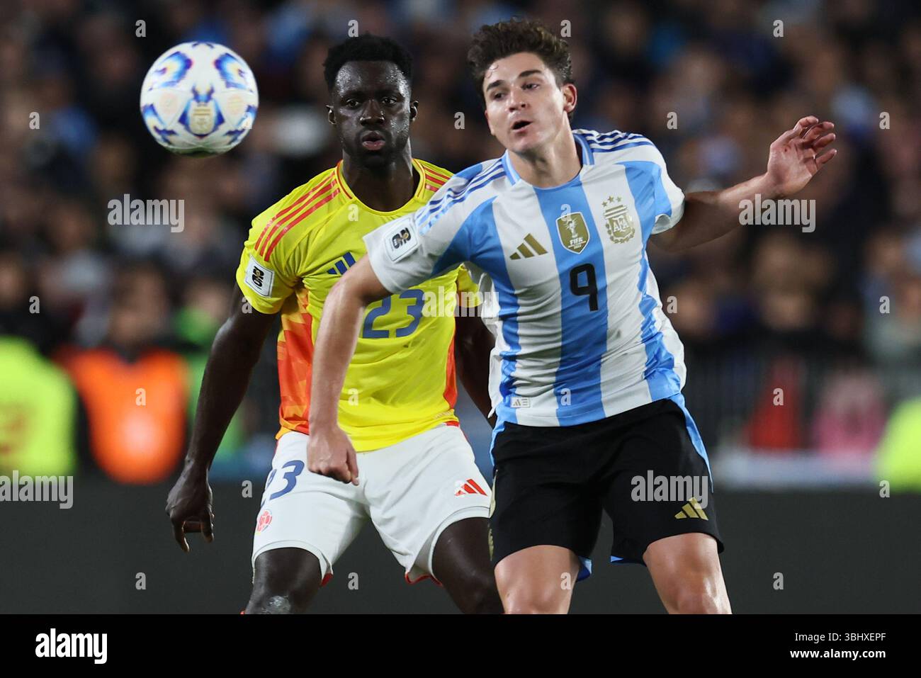 Argentina's national team forward Julian Alvarez (L) vies for the ball ...