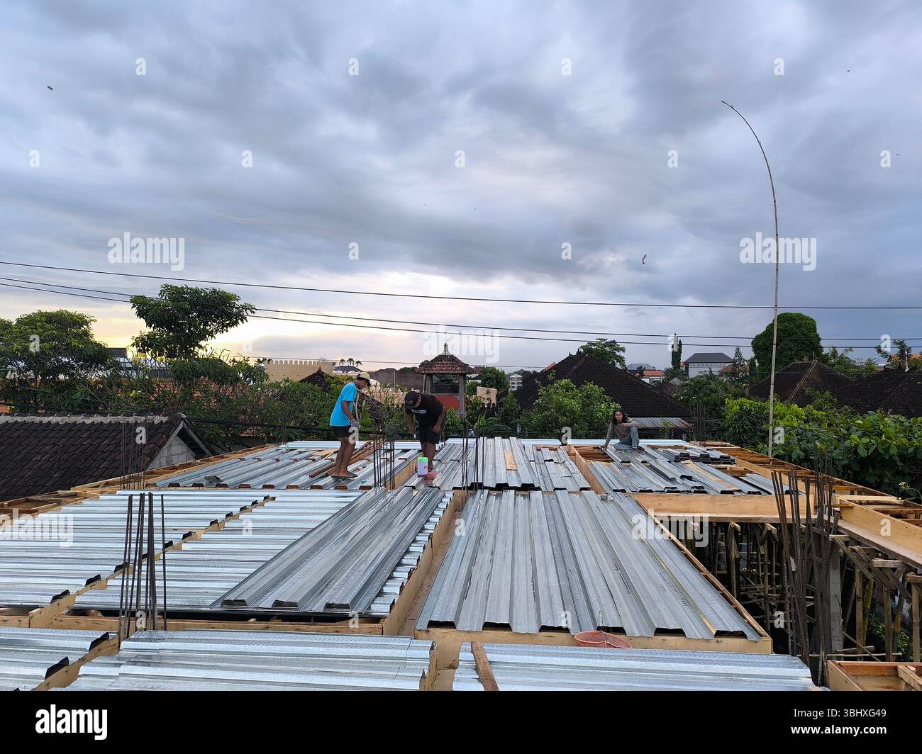 A construction worker is cutting zinc plates for the concrete base of ...