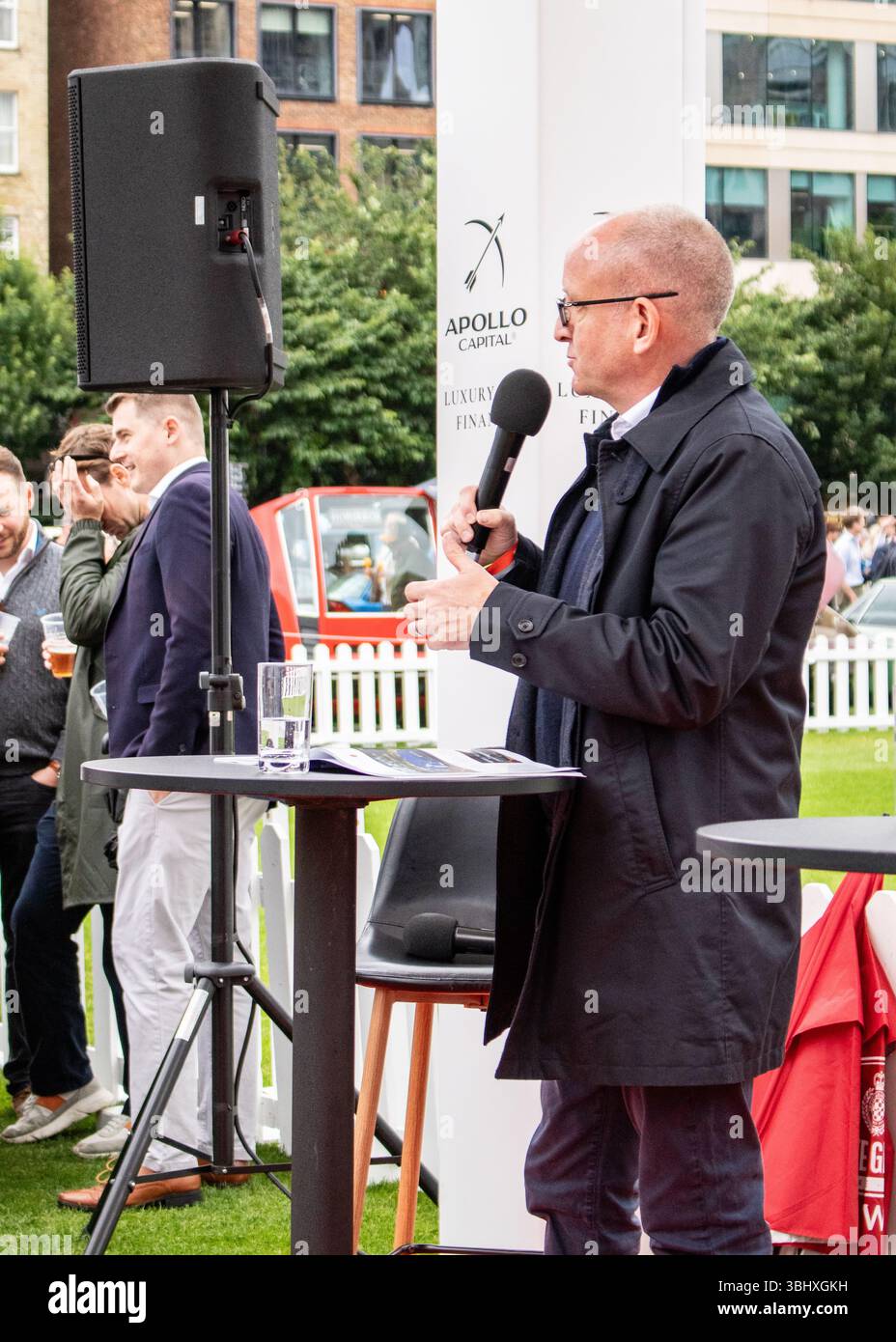 A presenter talks to the visitors at the London Concours classic car ...