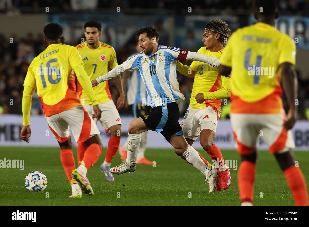 Argentina's national team forward Lionel Messi (C) vies for the ball ...