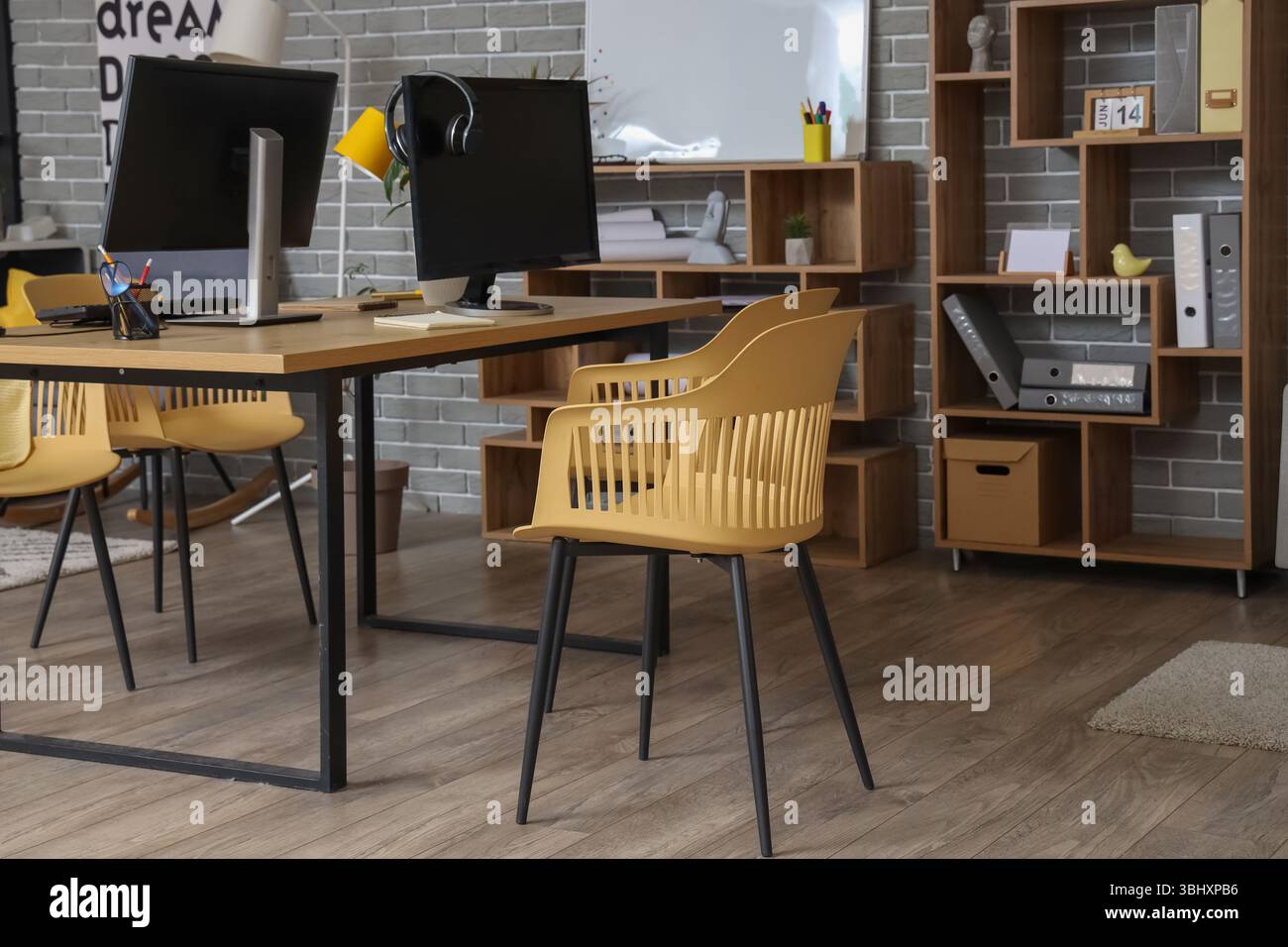 Interior of stylish office with workplace and shelf units Stock Photo ...