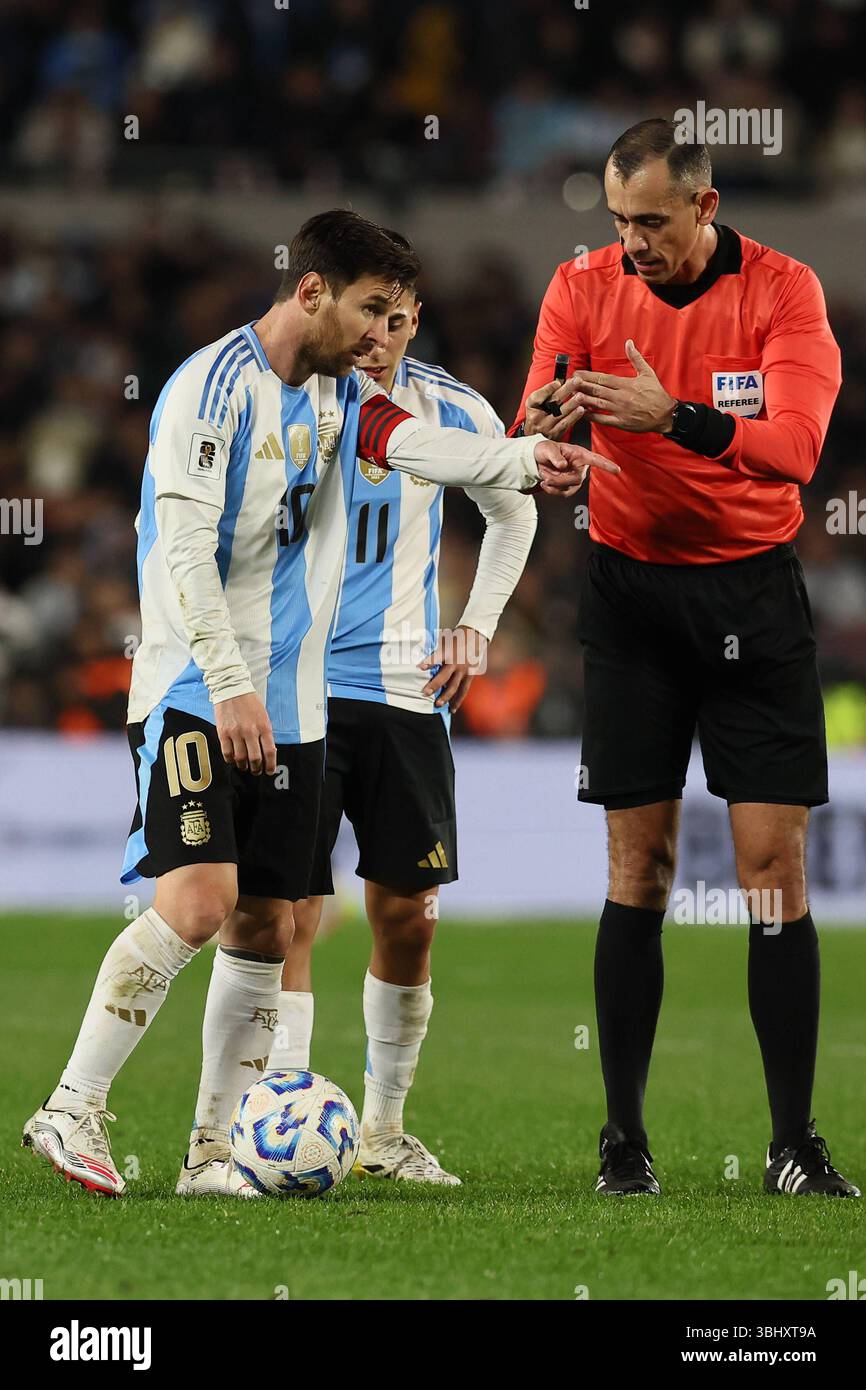 Argentinas national team forward Lionel Messi L argues Paraguayan referee Juan Beniez during the ...
