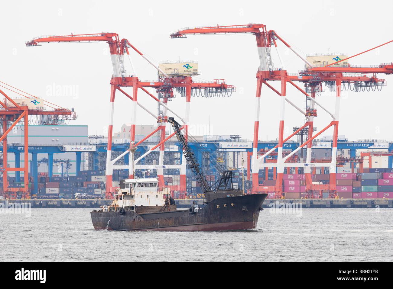 Tokyo, Japan. 14th May, 2025. A ship drives passes a container ship ...