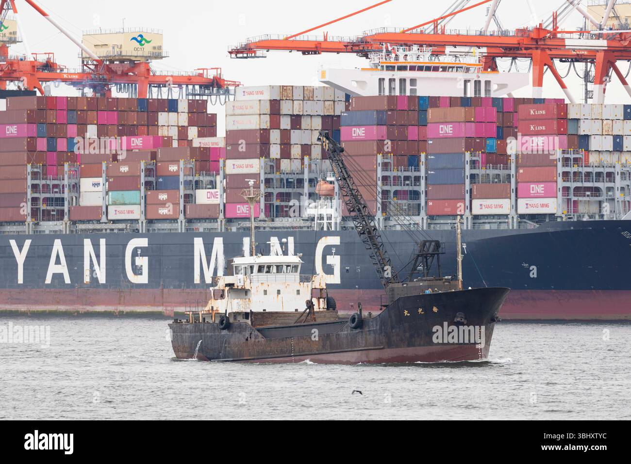 Tokyo, Japan. 14th May, 2025. A ship drives passes a container ship ...