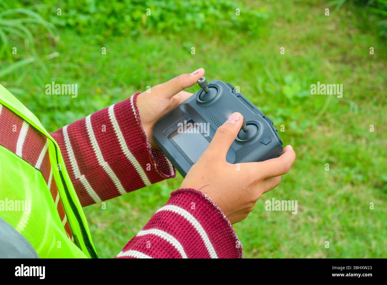 Young Asian woman flying a drone in nature Stock Photo - Alamy