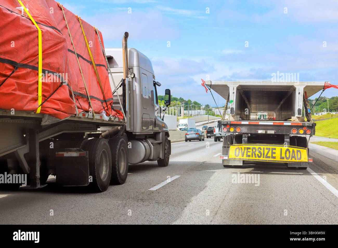 Large trucks carry oversized loads on crowded highway transportation in ...