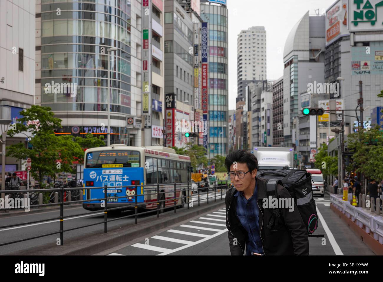 Tokyo, Japan. 29th May, 2025. Uber Eats cyclist rides his bicycle in ...