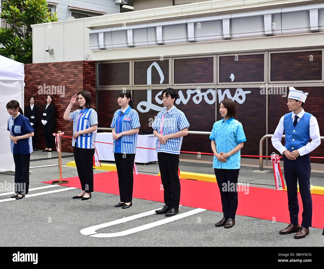 Convenience store chain Lawson's past uniforms are on display in front ...