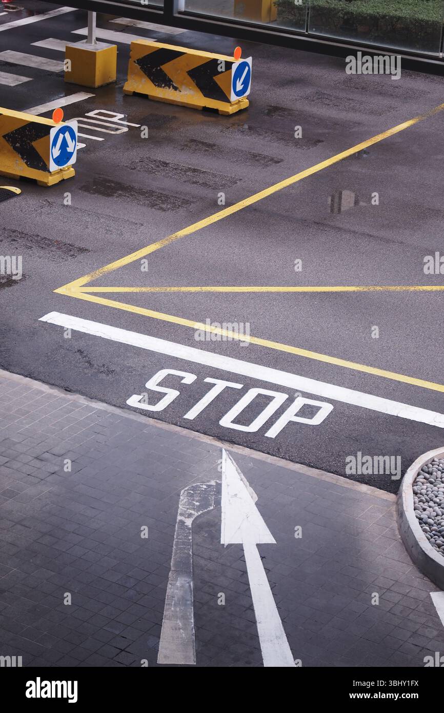 Urban parking area with clear stop sign and direction Stock Photo - Alamy