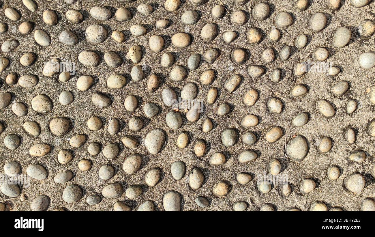 "Pebble-Coated Surface with Embedded Rounded Stones in Natural Tones ...