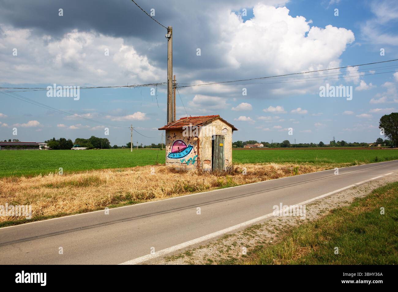 Old rural building street art vibrant colors green fields country road ...