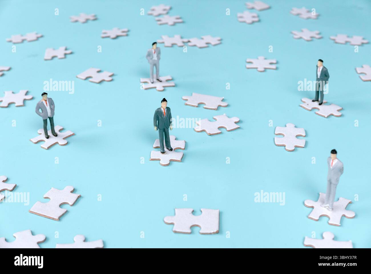 Five Businessmen Standing on Separate Jigsaw Puzzle Pieces ...