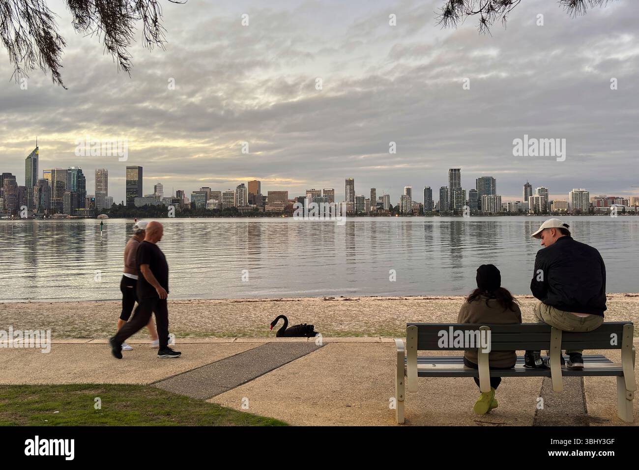 People enjoy their free time on the shore of the Swan river in Perth ...