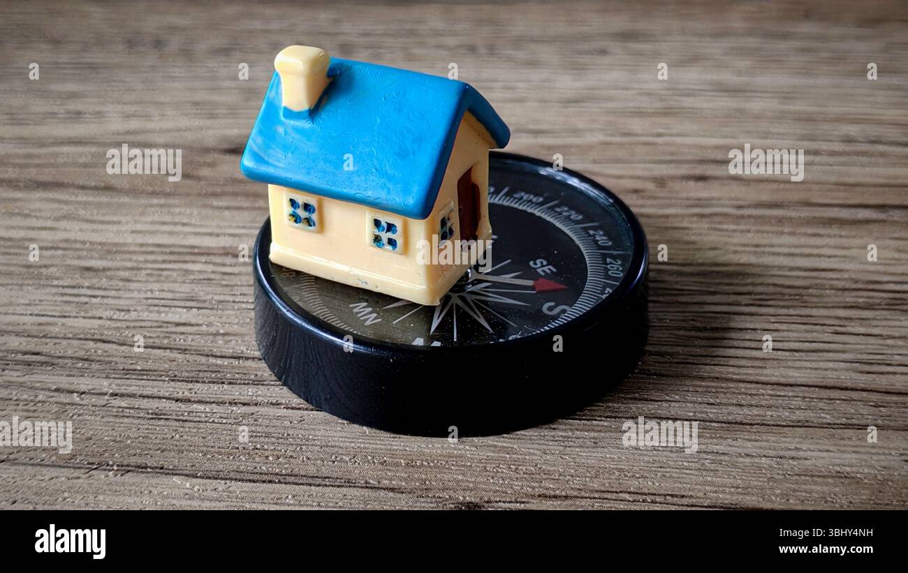 miniature house on a compass Stock Photo - Alamy