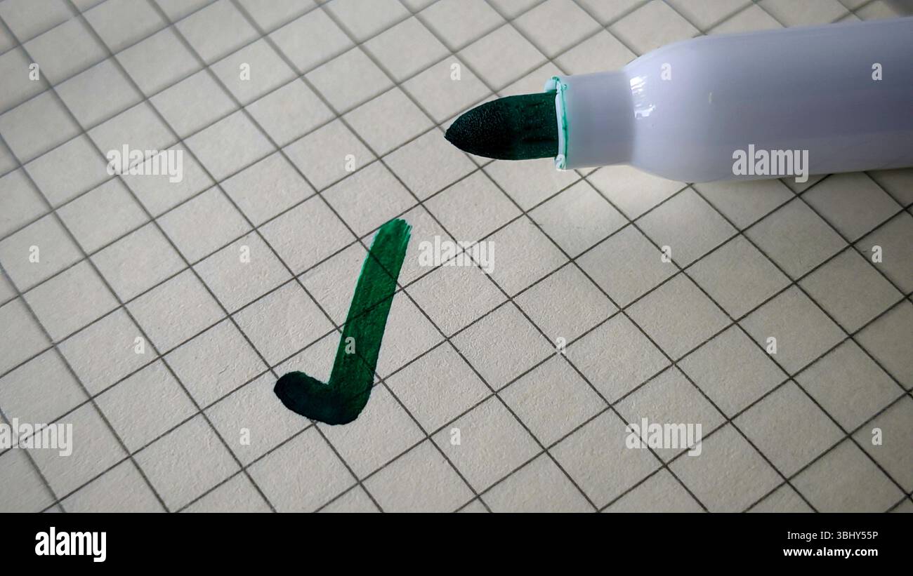 Green Check Mark on Graph Paper Stock Photo - Alamy