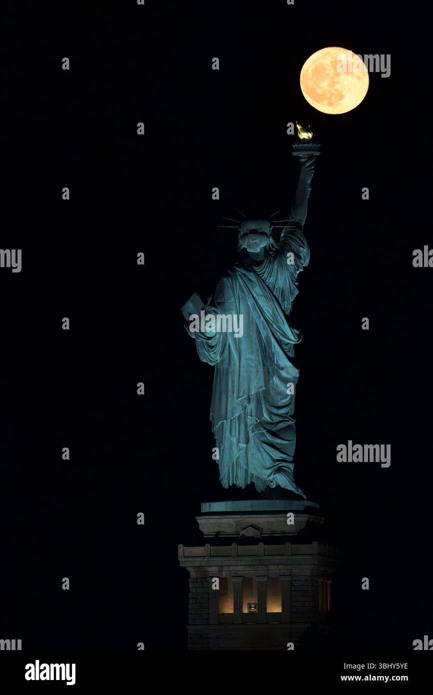 The so-called strawberry moon rises over Statue of Liberty in New York ...