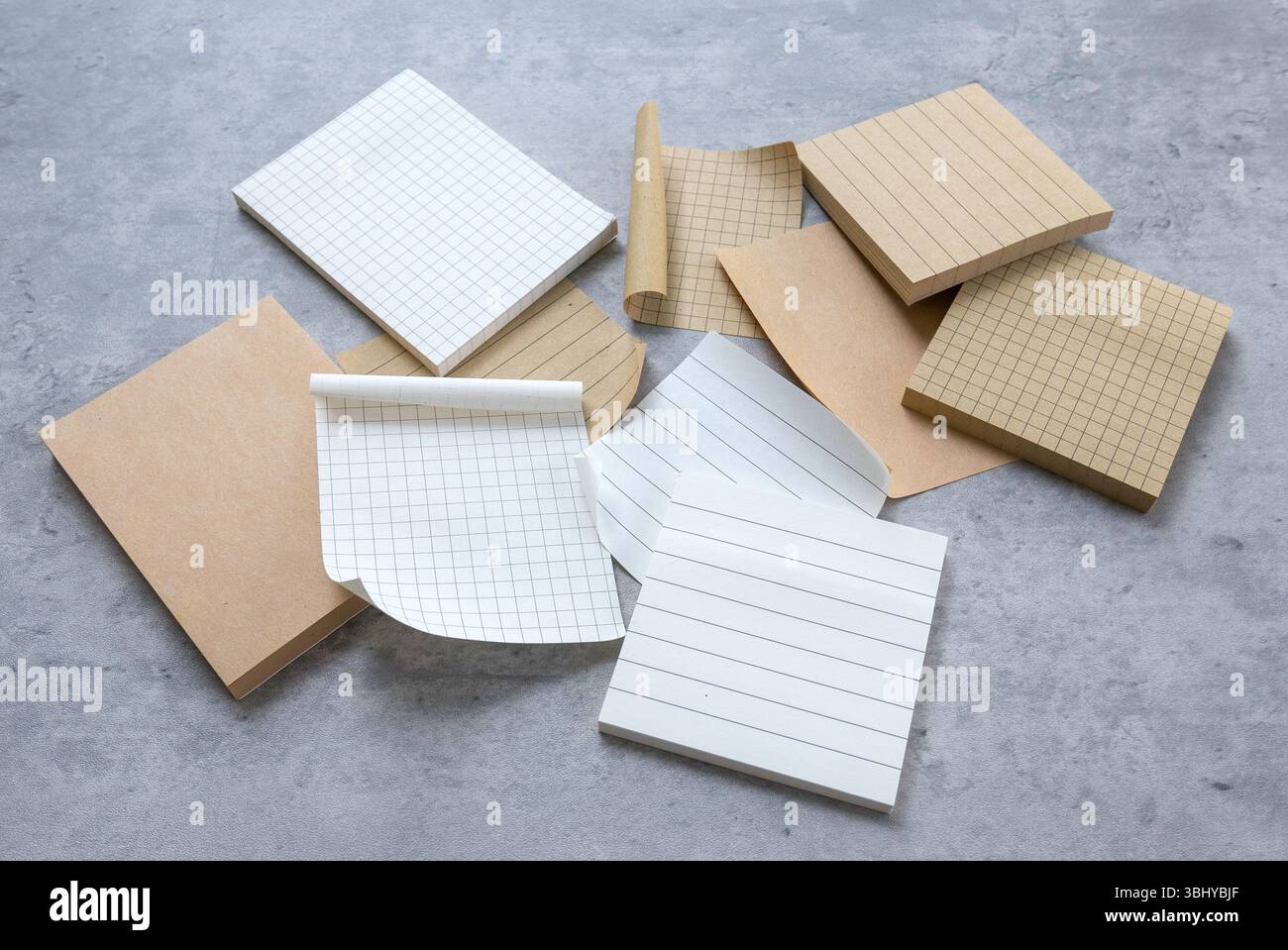 Variety of Paper Types: Lined, Grid, and Plain Sheets on a Gray Surface ...