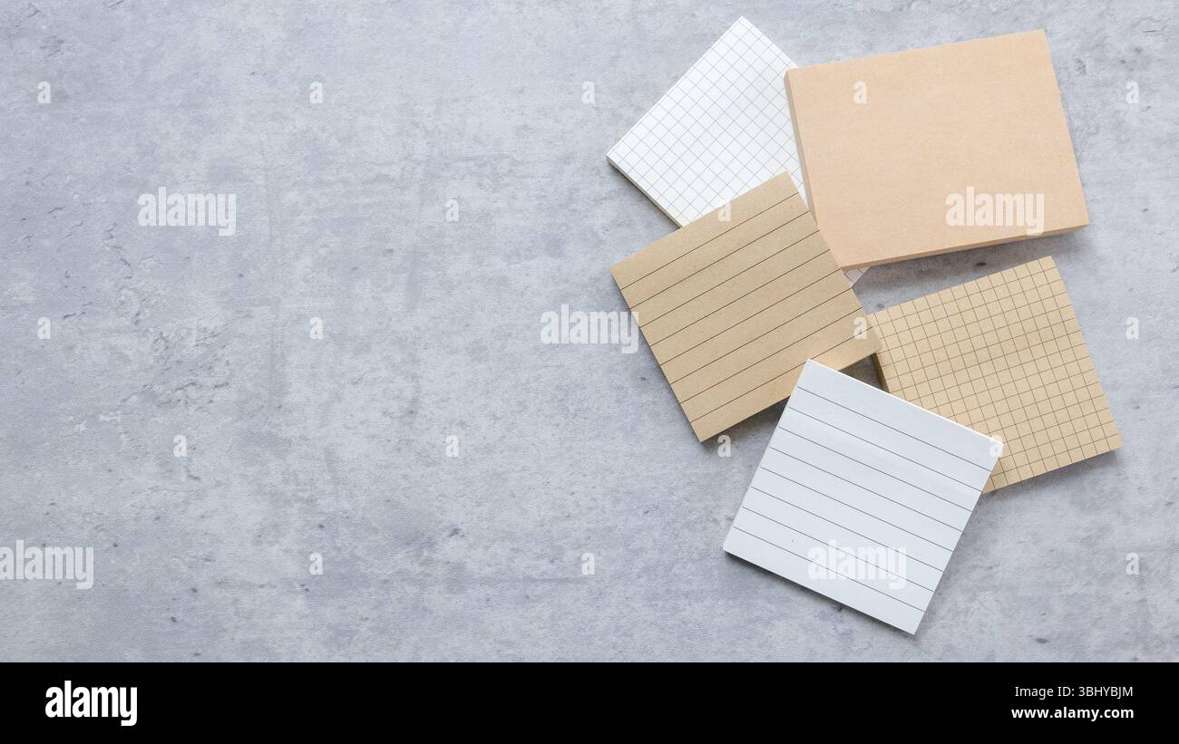 Variety of Paper Types: Lined, Grid, and Plain Sheets on a Gray Surface ...