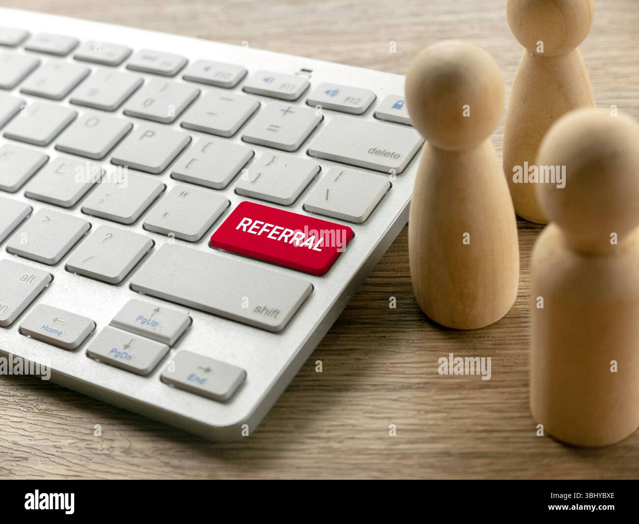 Referral Button Keyboard with Wooden People Figures Stock Photo - Alamy
