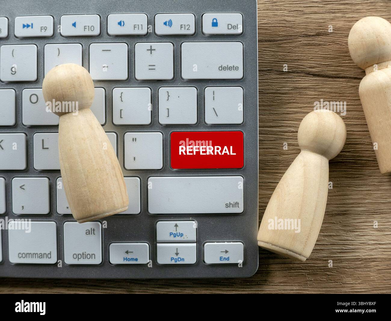 Referral Button Keyboard with Wooden People Figures Stock Photo - Alamy