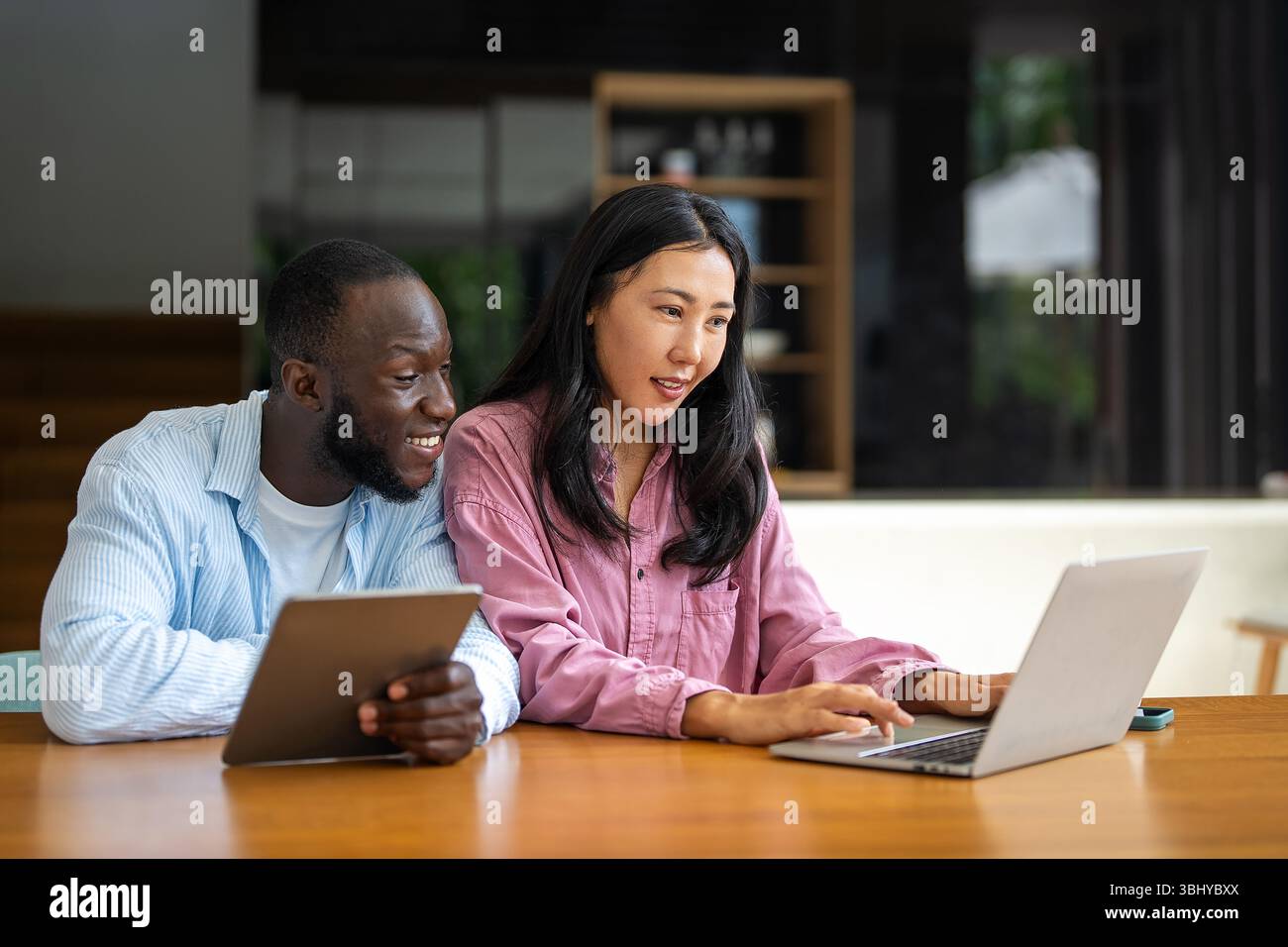 Digital lifestyle, online connectivity. Diverse couple enjoying ...
