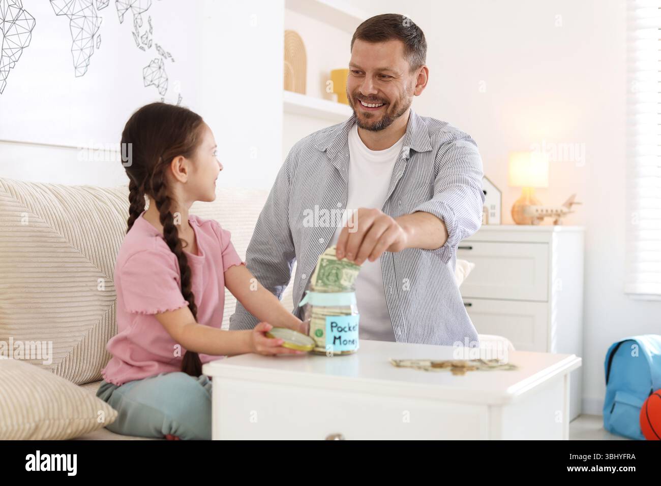 Father daughter coins hi-res stock photography and images - Alamy