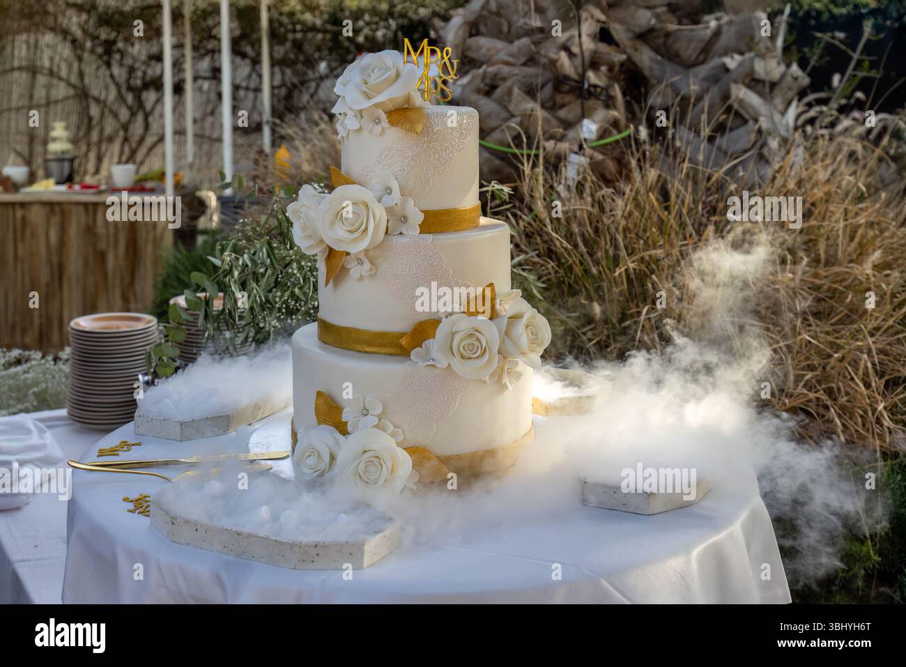 Beautiful wedding cake display with soft smoke creating a dreamy ...