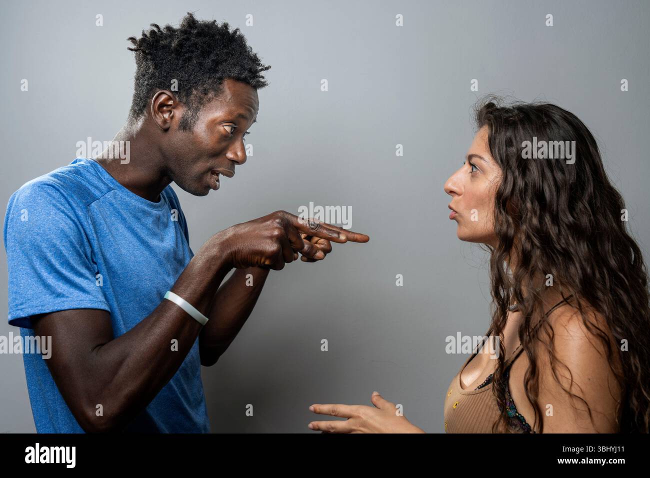 A man points an accusing finger at his partner during a heated argument ...